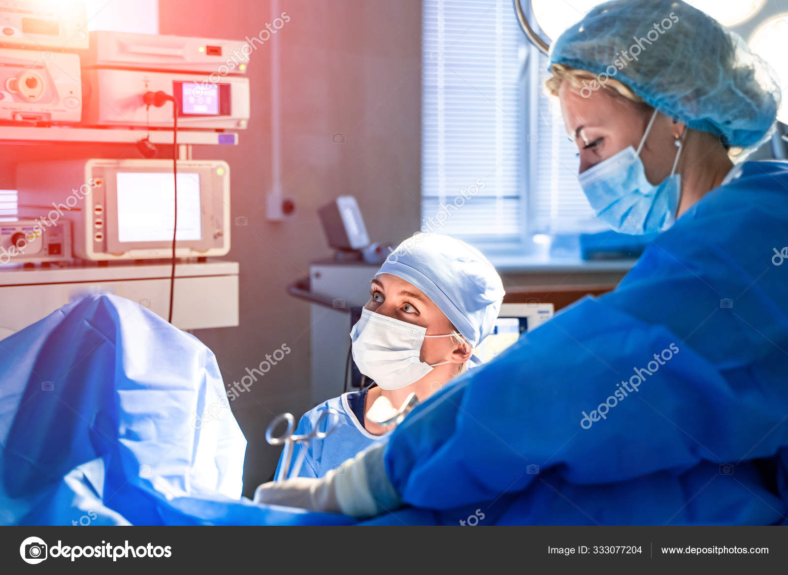 Process of surgery operation. Group of surgeons in operating room with ...