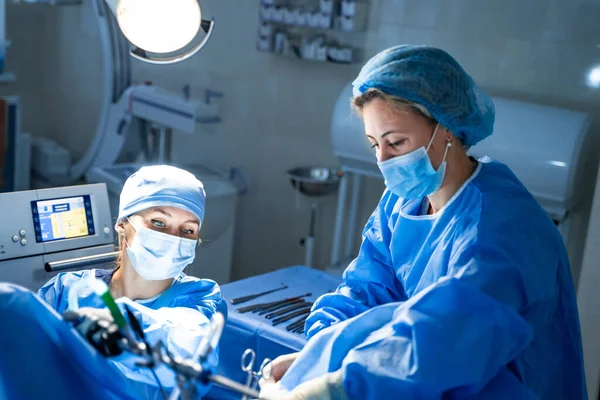 Process of surgery operation. Group of surgeons in operating room with ...