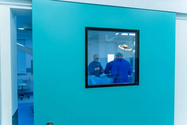 Process of trauma surgery operation. Group of surgeons in operating ...