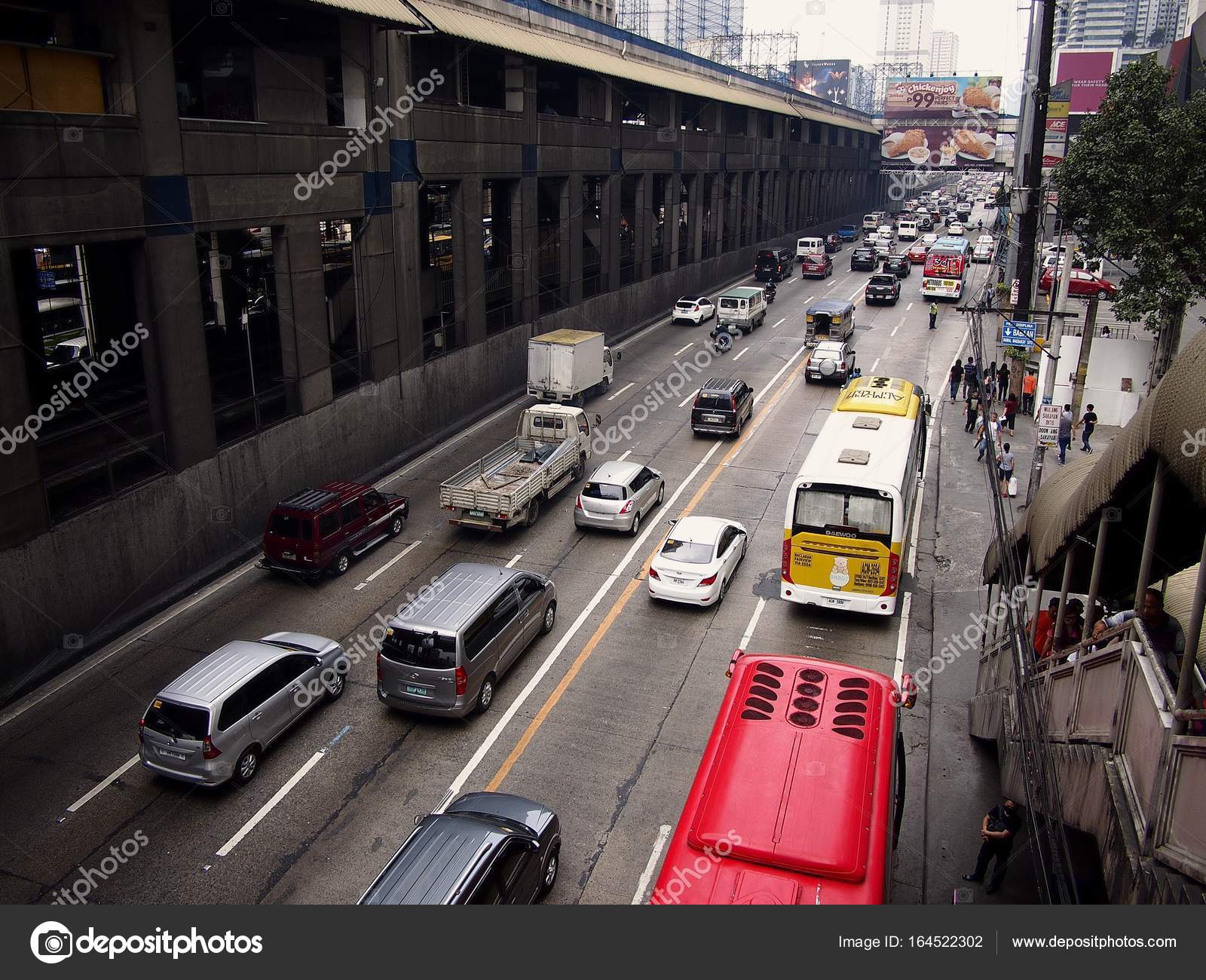 Private and public vehicles passing along EDSA and the Boni MRT Station ...