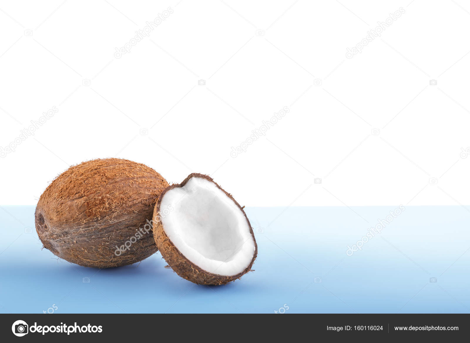 Brown coconut on a bright light blue background. Fresh coconut cut in ...