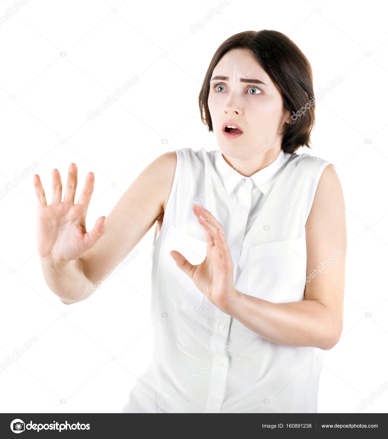 A terrified girl isolated on a white background. A scared girl ...