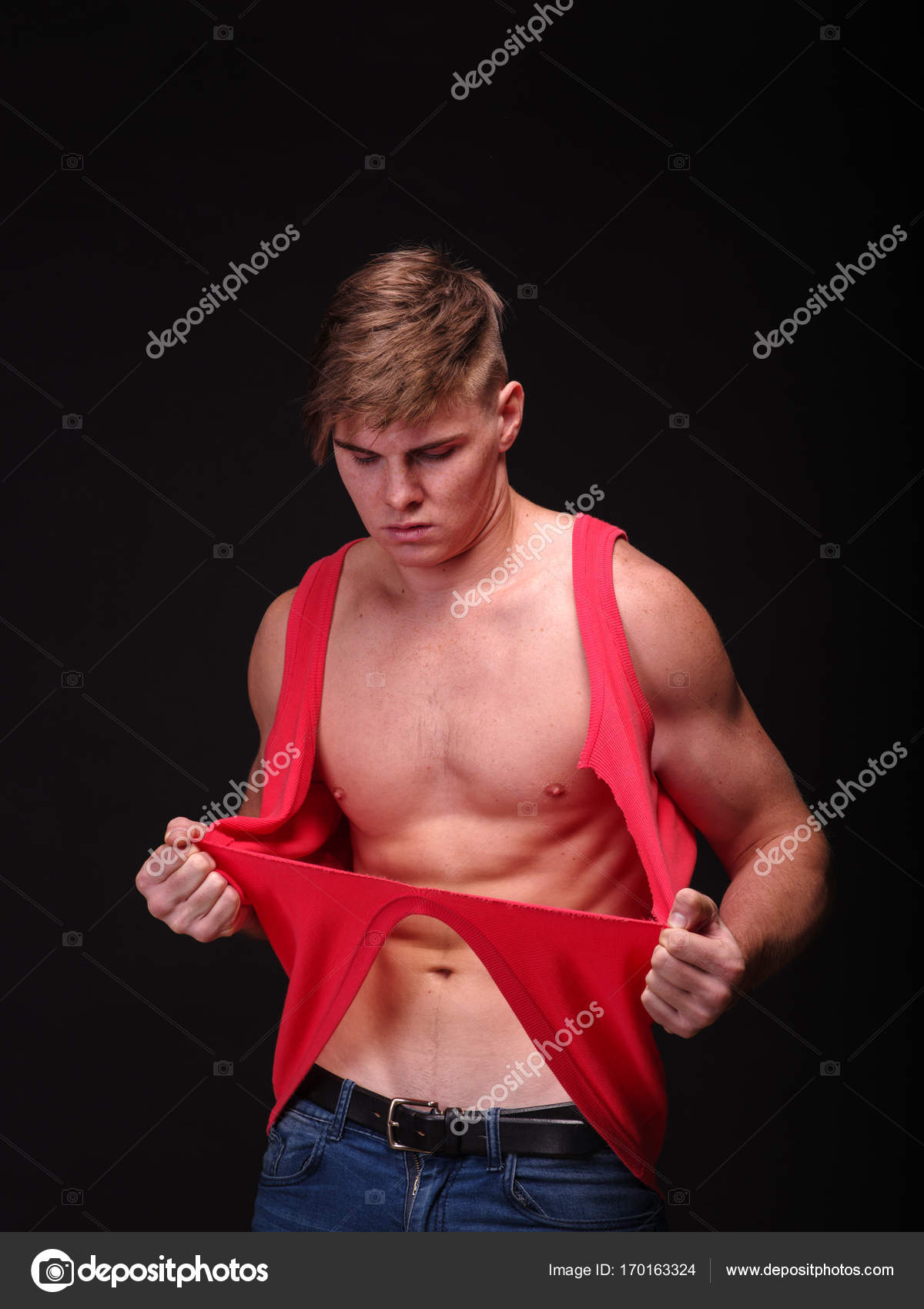 Sexy Handsome Young Man Tearing Shirt Off On A Black Background Fitness And Workout Concept