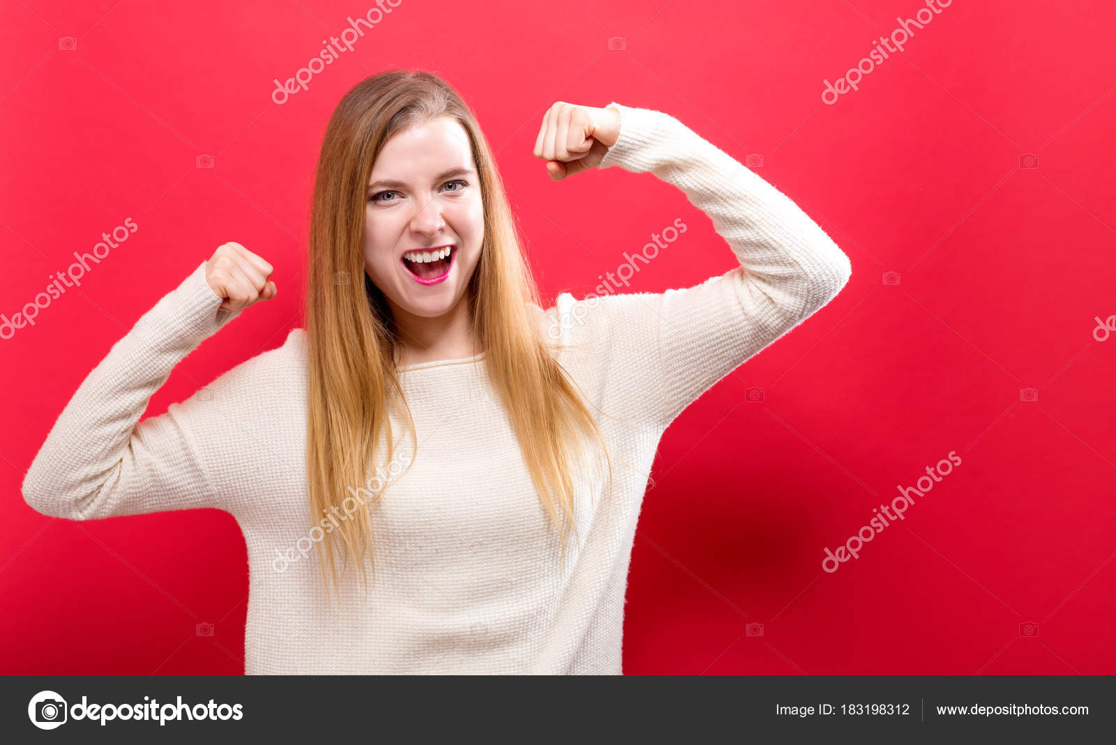Powerful young woman in a success pose — Stock Photo © Melpomene #183198312