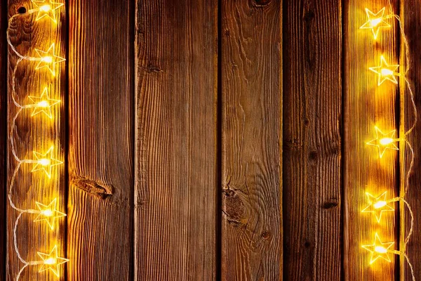 Christmas lights on wooden rustic background. - Stock Image - Everypixel