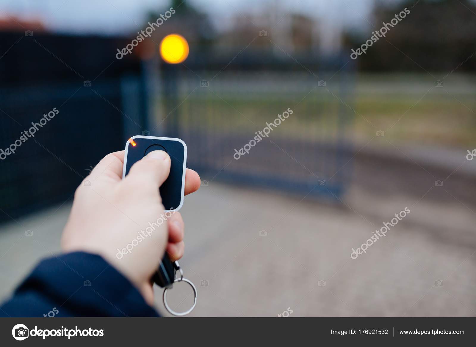 Man opening automatic property gate Stock Photo by ©djedzura 176921532