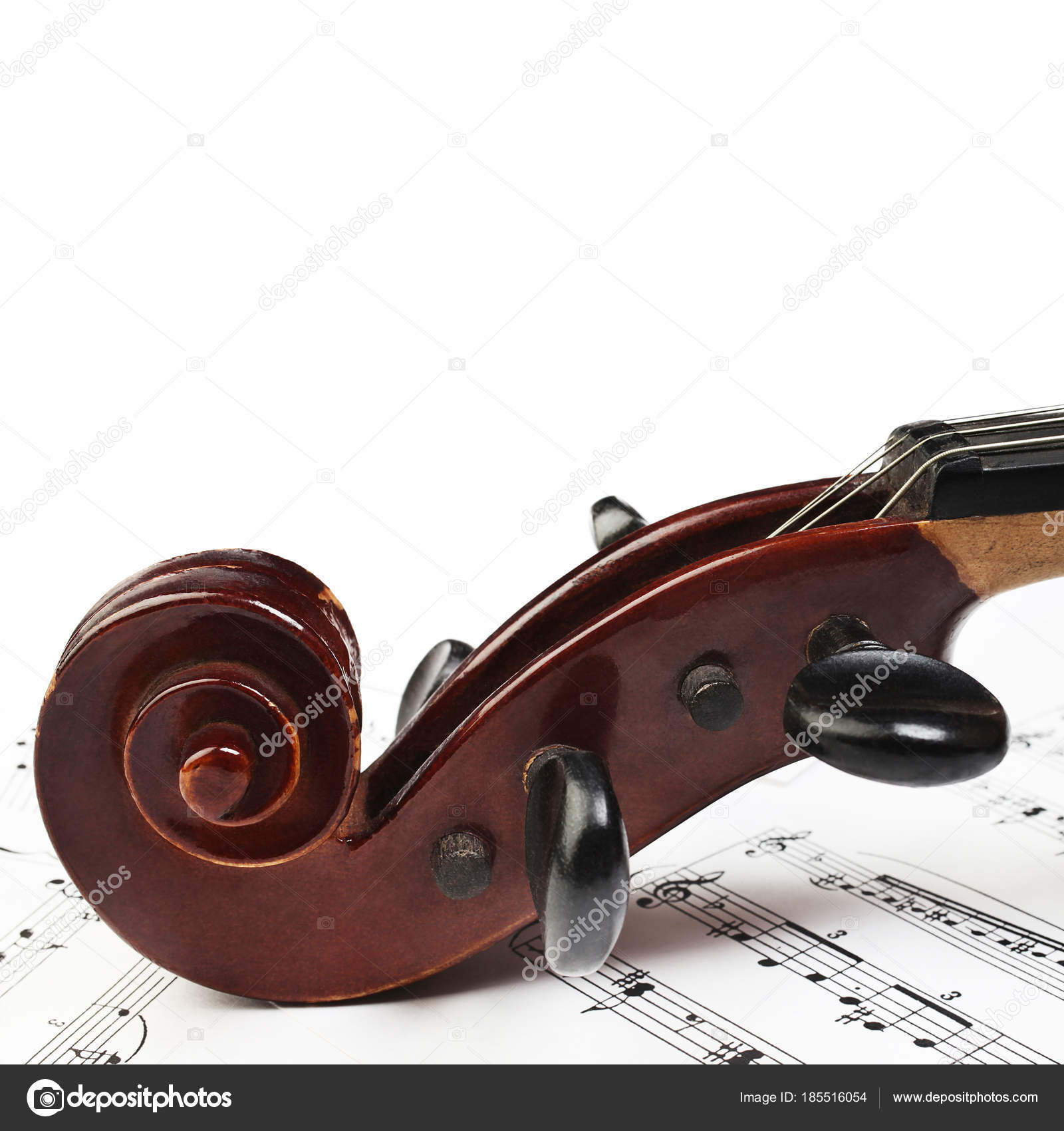 Violin scroll with music sheet notes Stock Photo by ©alenavlad 185516054