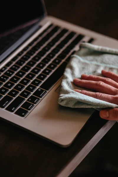 Woman disinfects and cleans laptop keyboard at home, with antibacterial ...