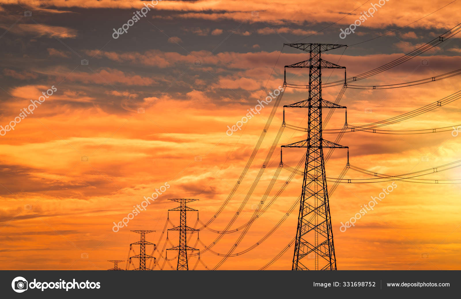 High voltage electric pole and transmission line in the evening ...
