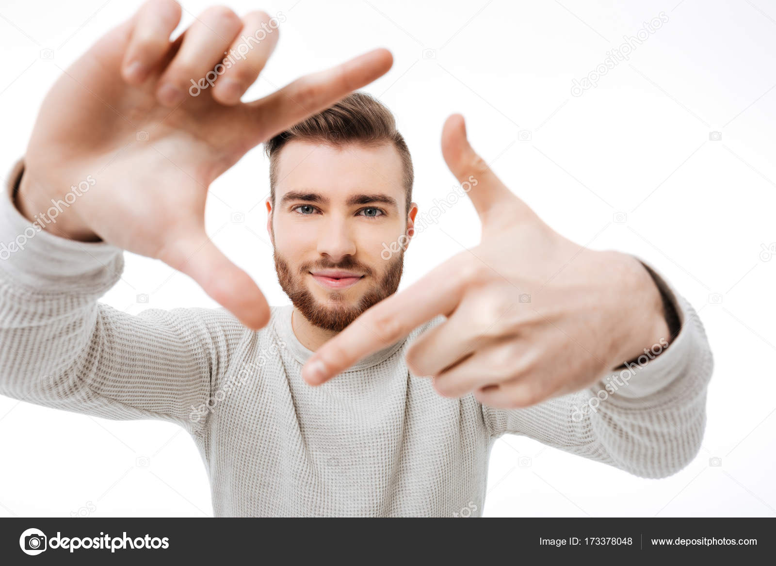 Young man making finger frame as a director of photography and smilibg ...