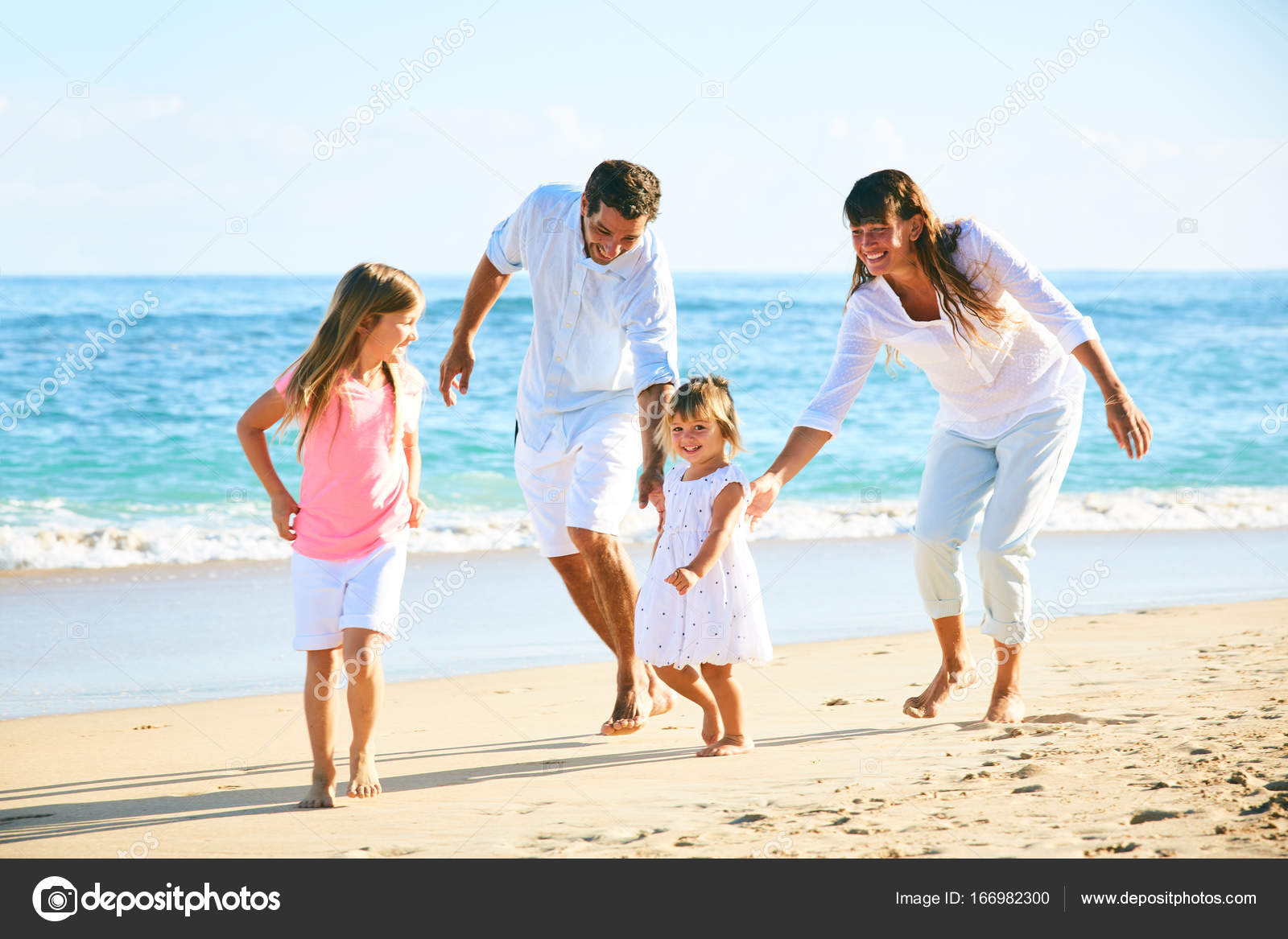 Familia feliz en la playa: fotografía de stock © EpicStockMedia #166982300 | Depositphotos