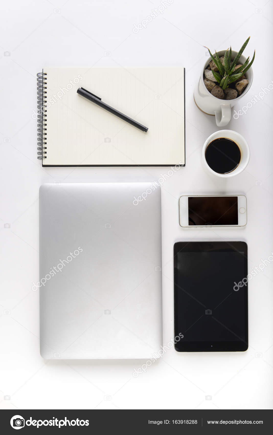 Office table with laptop computer, notebook, digital tablet and ...