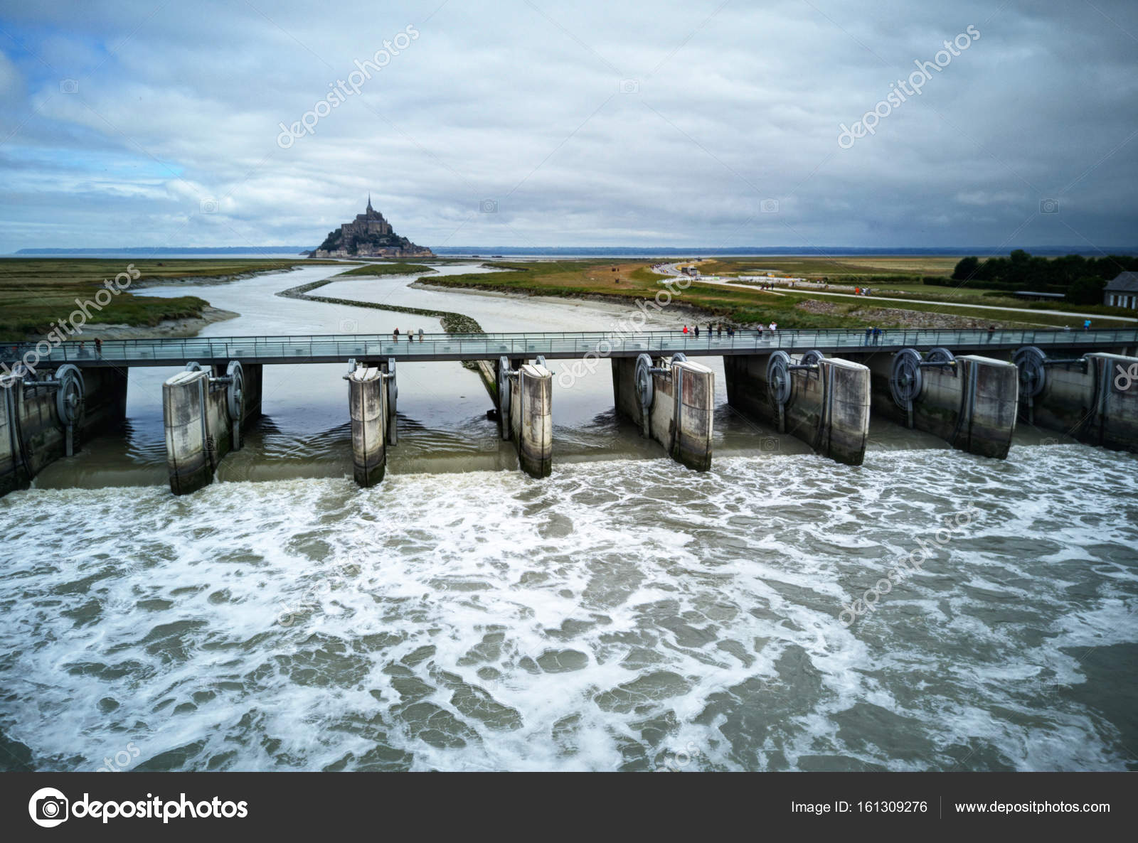 High tide on the dam with Mont-Saint Michel abbey view Stock Photo by ...