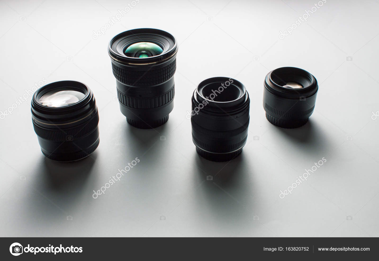 Close-up view of a group of camera lenses on a white surface — Stock ...