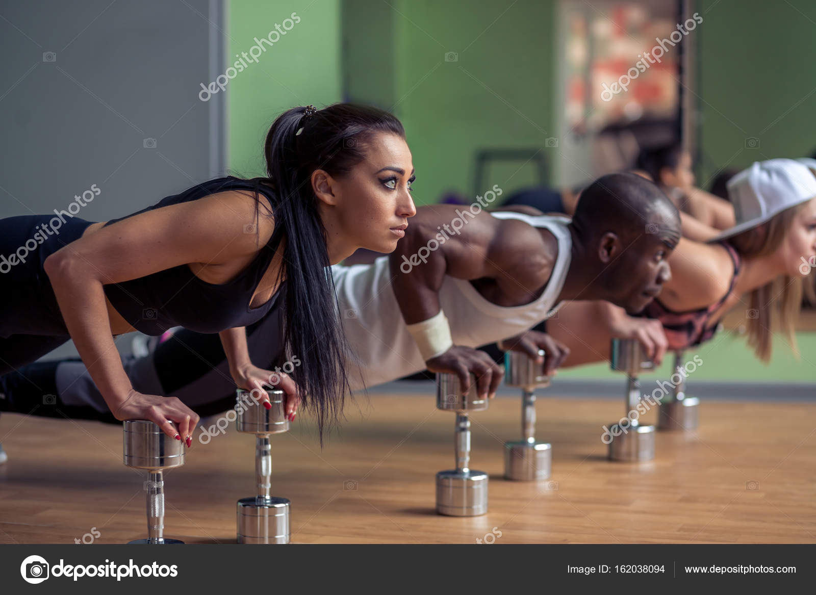 Side view of a group of fitness people doing push ups — Stock Photo ...