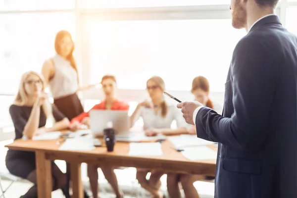 View of a Boss heading a business reunion with partners - Stock Image ...