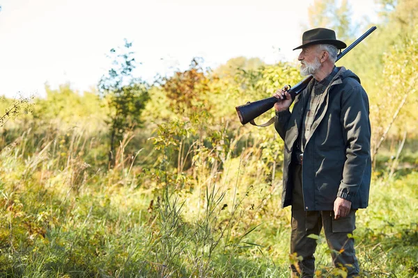 Senior hunter stand relaxing after hunting - Stock Image - Everypixel
