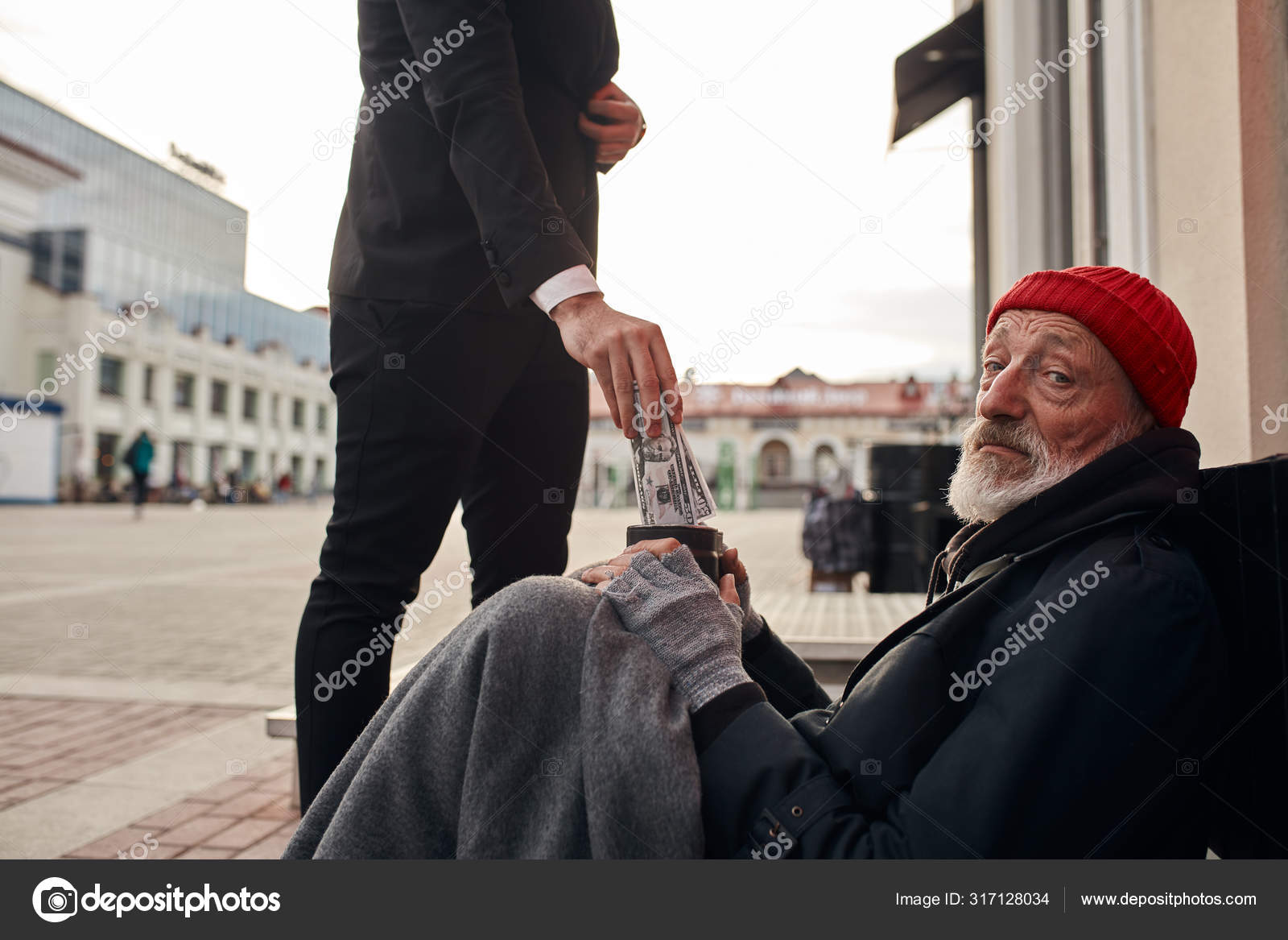 Man Giving Money To Homeless