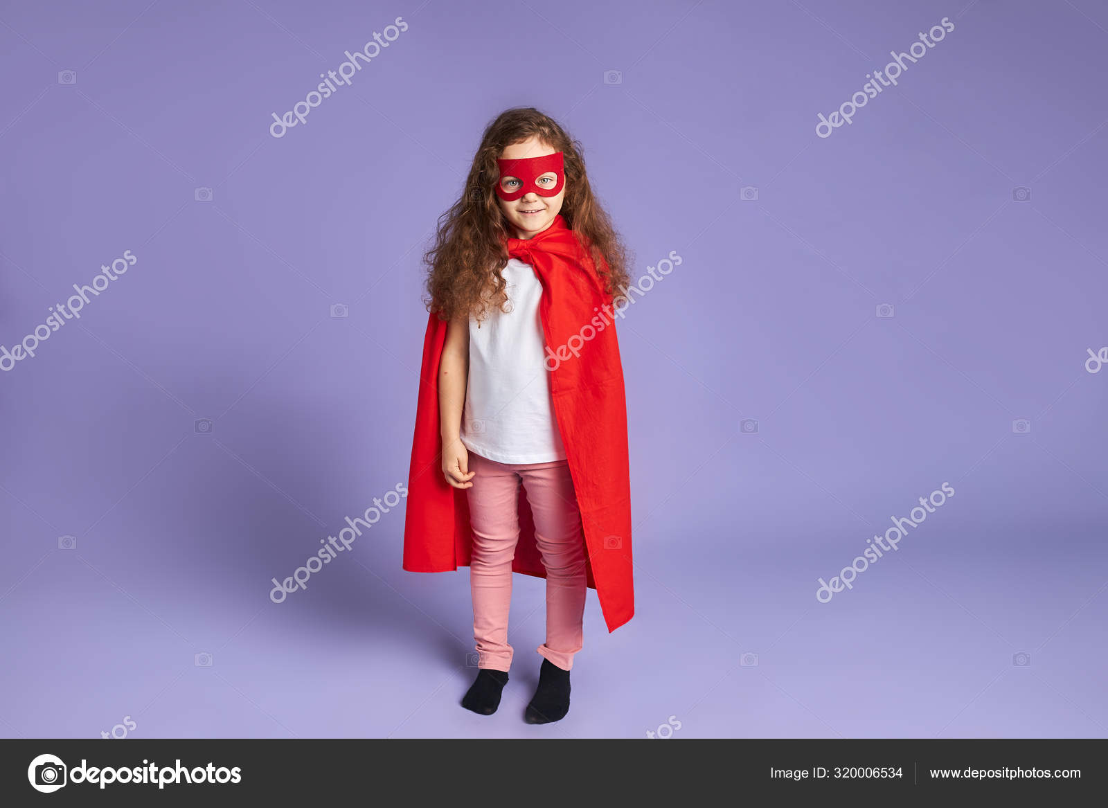 Little kid wearing red suit and mask imagines herself as superhero ...
