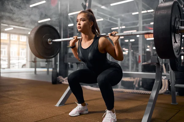 Pretty fit woman squatting with weight Stock Photo by ©ufabizphoto ...