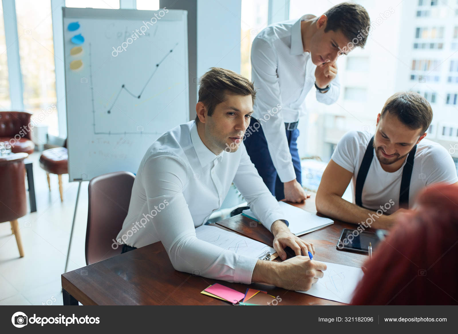 Teamwork process of young team of caucasian coworkers making great ...