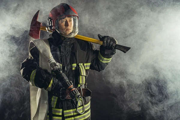 Fireman with hammer dont afraid of danger and fire — Stock Photo ...