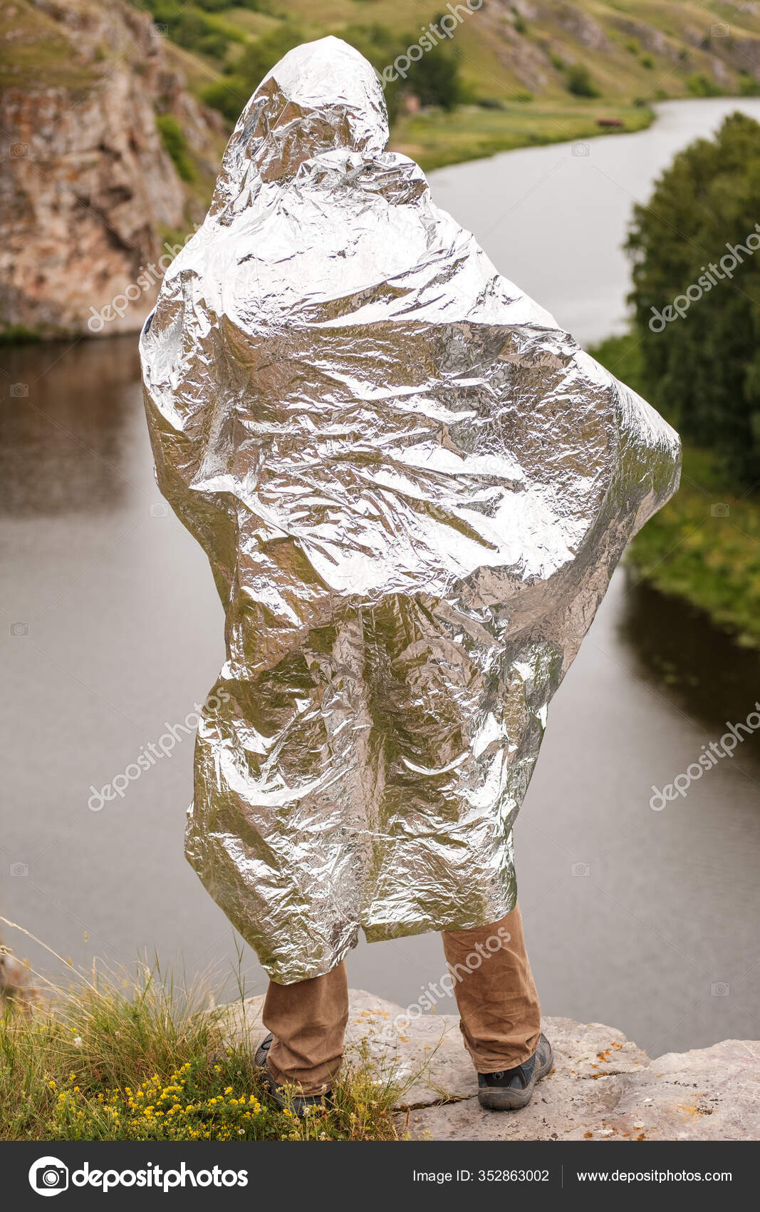 Figure Bright Foil Cape Stands Background Rock River Strange Man Stock ...