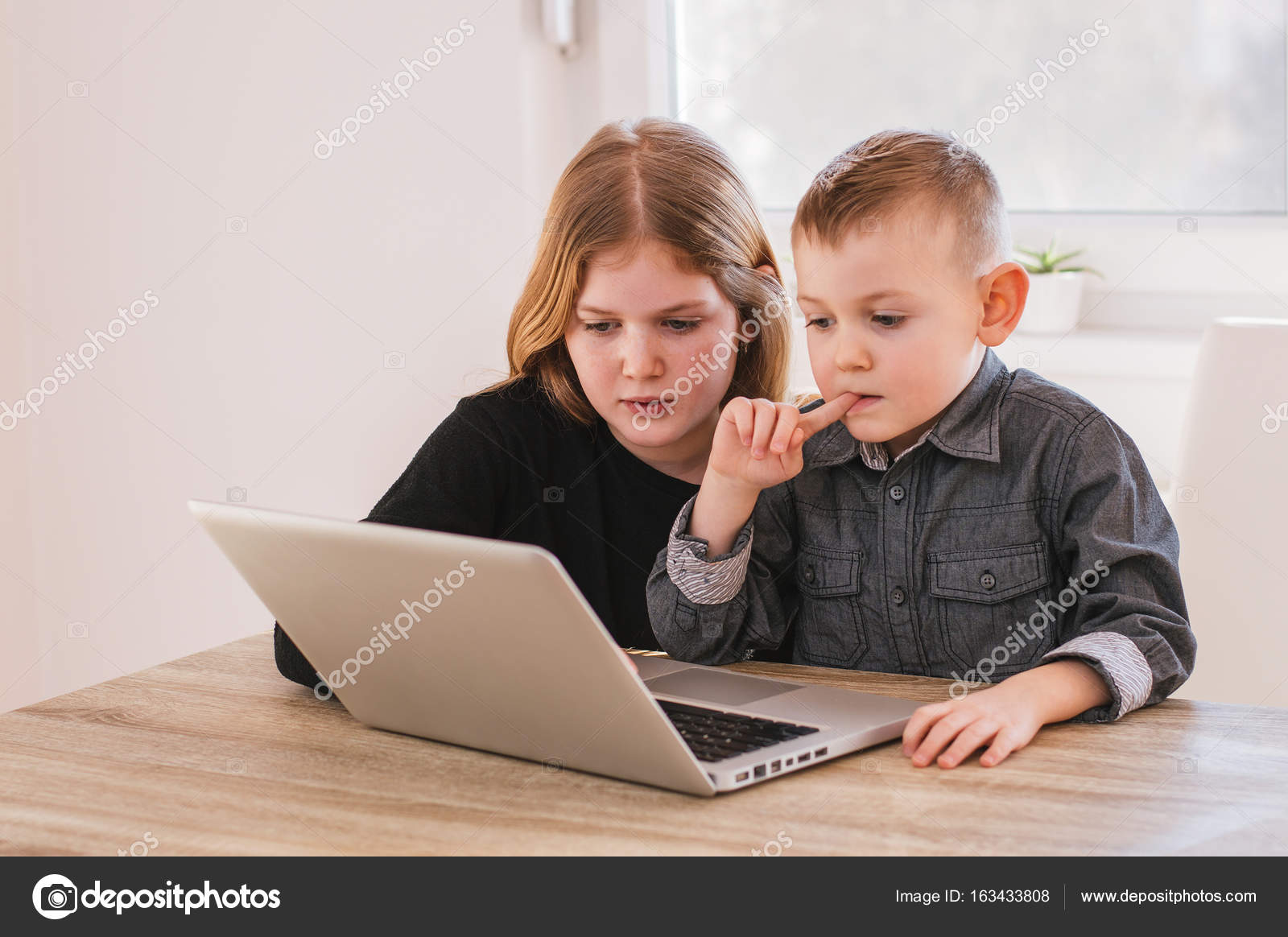Kids playing on computer Stock Photo by ©bnenin 163433808