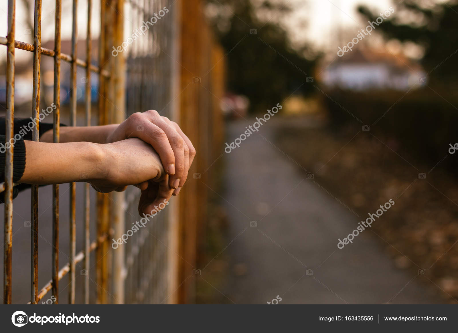 Hands sticking out through grate Stock Photo by ©bnenin 163435556