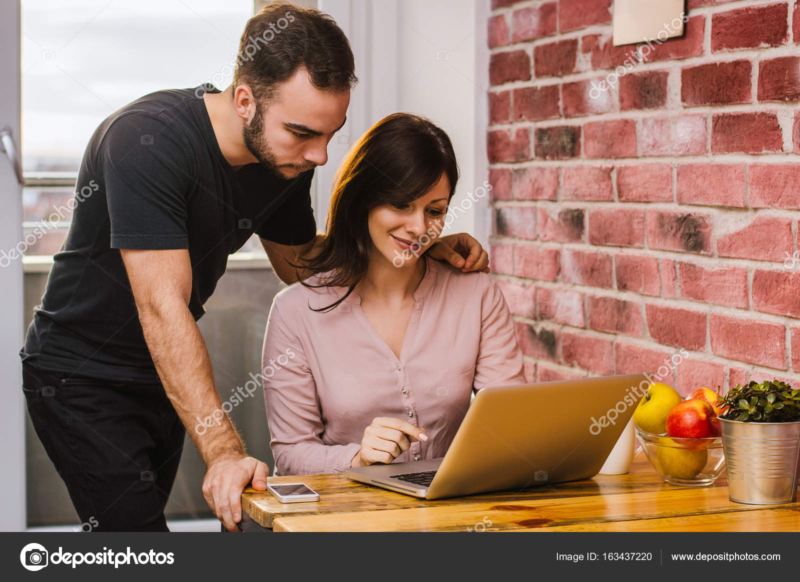 Young couple working with laptop Stock Photo by ©bnenin 163437220
