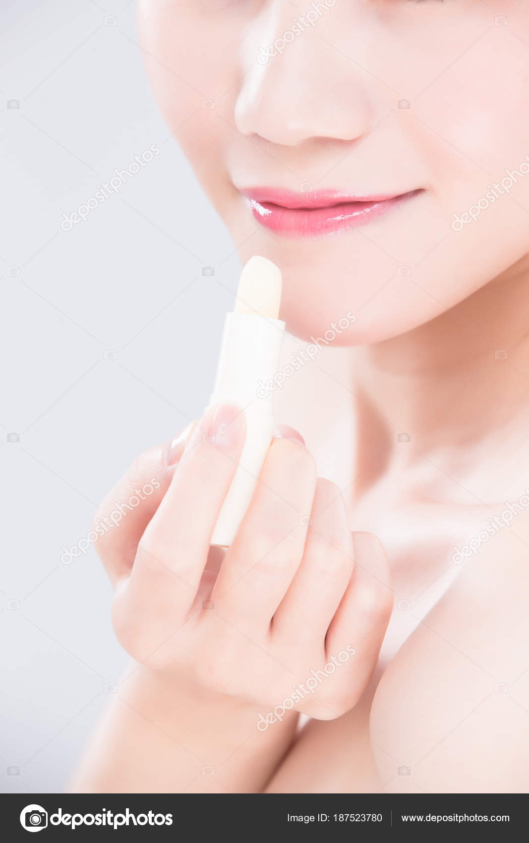 Woman Use Lip Balm Gray Background Stock Photo by ©ryanking999 187523780