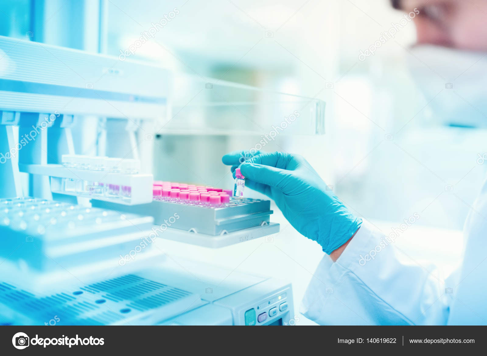 Close up of chemist scientist holding sample and examining test tube in ...