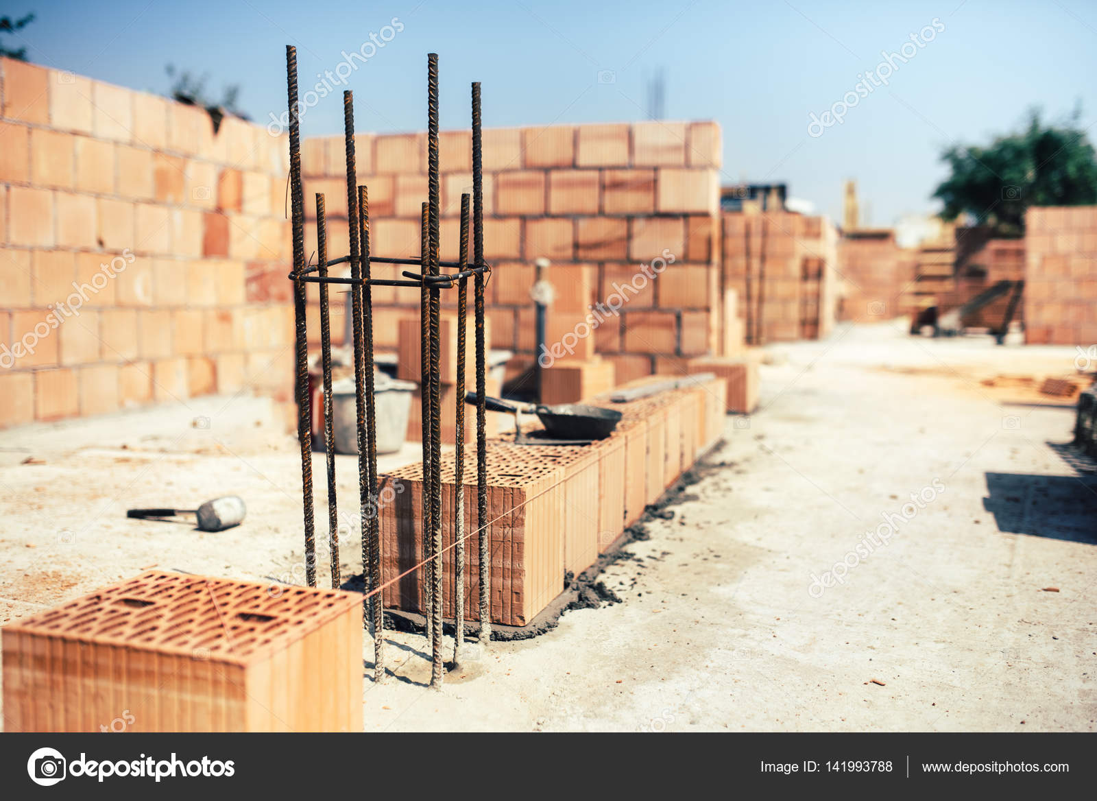Industrial construction site, placing bricks on cement while building ...
