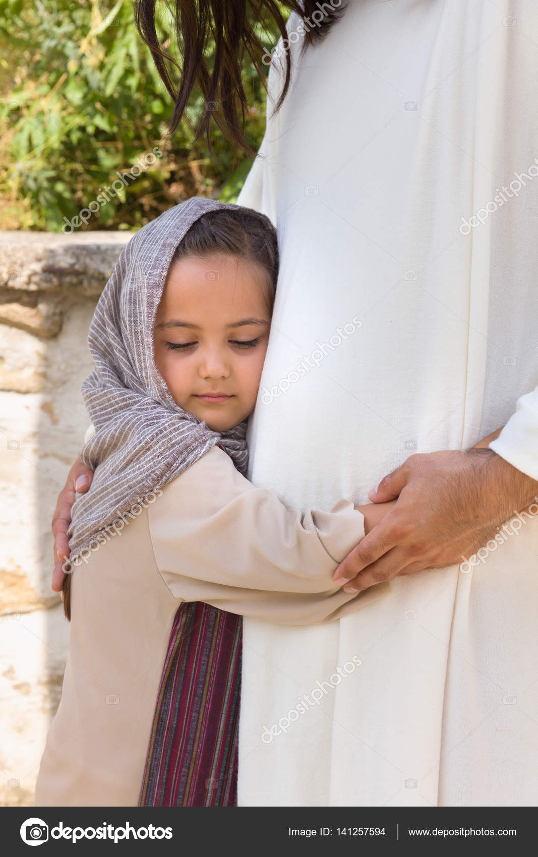 Little girl hugging Jesus — Stock Photo © Klanneke #141257594