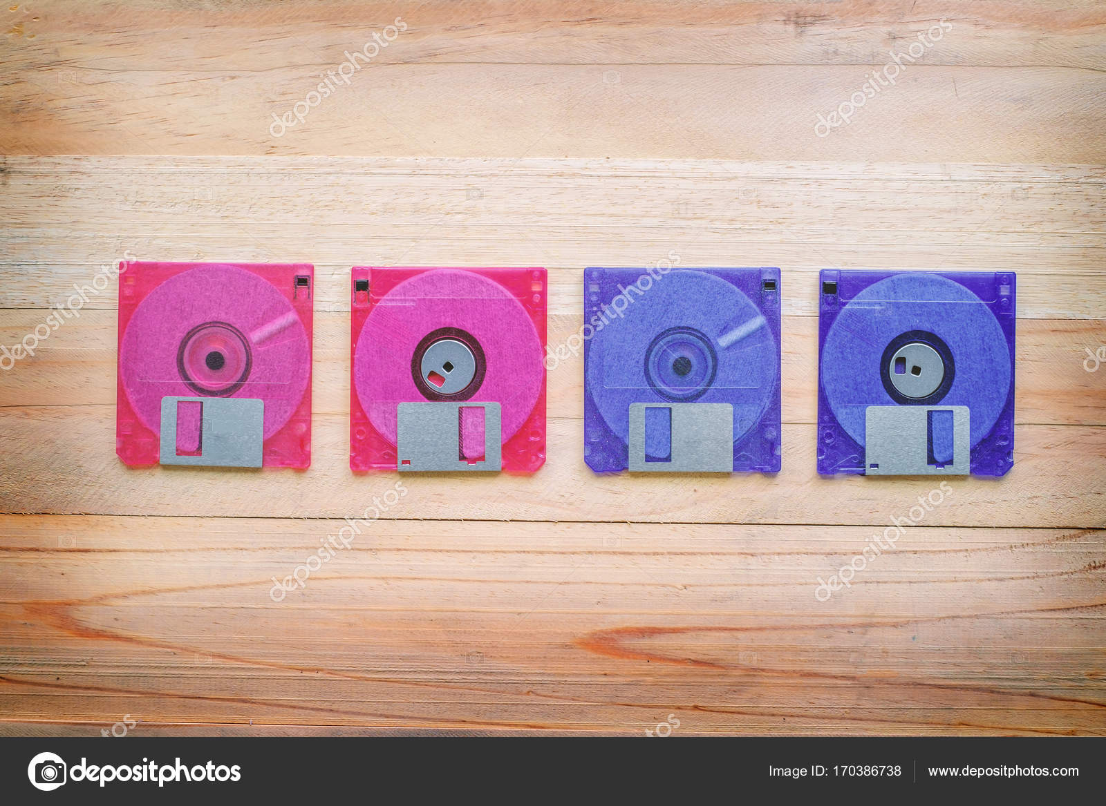 Front and back of floppy disk on wooden table, old technology and ...
