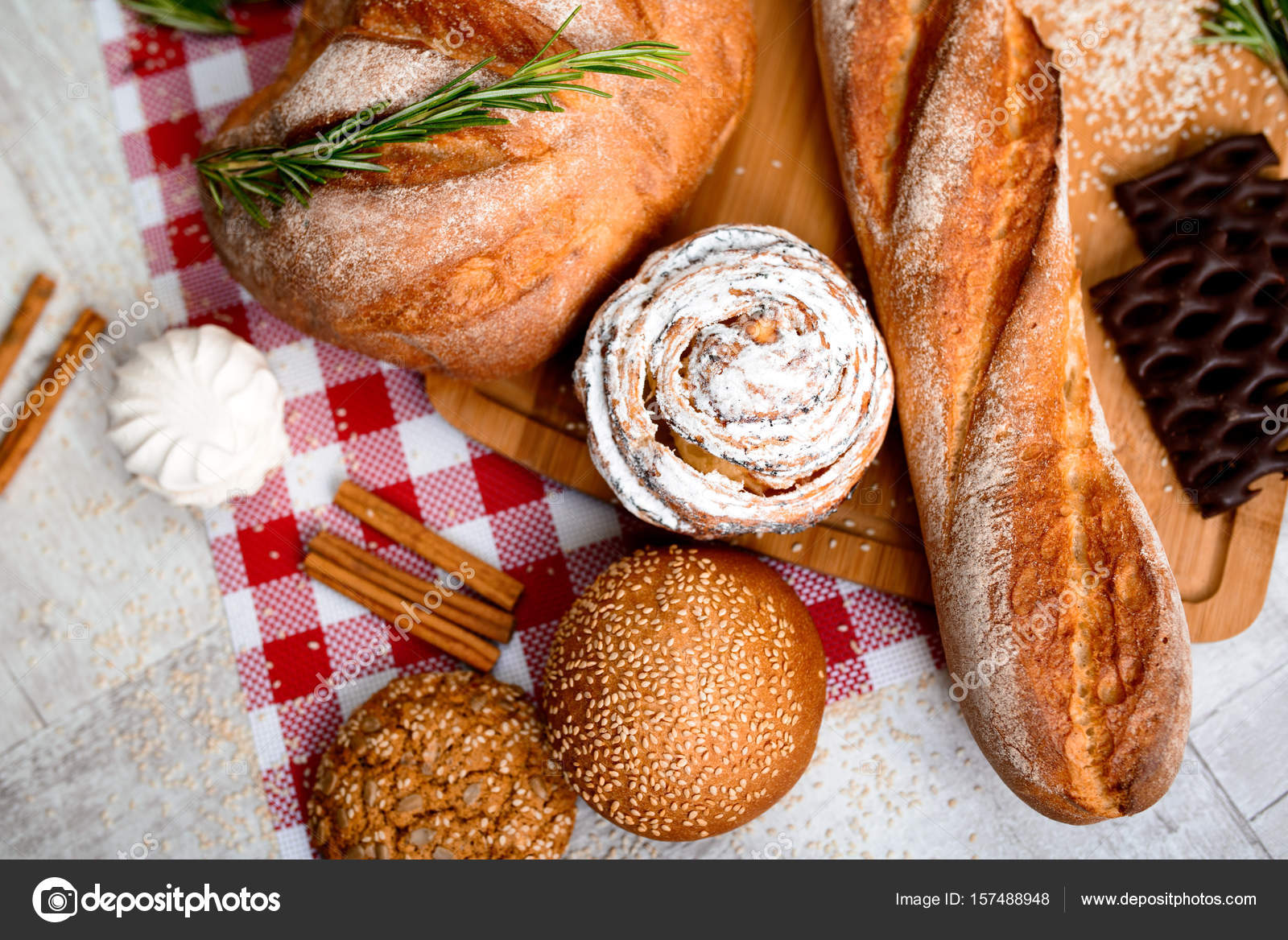 Freshly baked bread. Different types of bread and rolls on Board ...