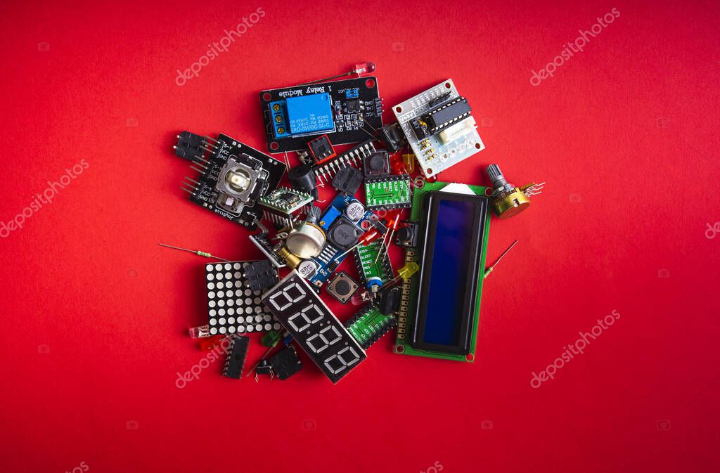 Micro electronics arduino DIY components over red background, top view ...