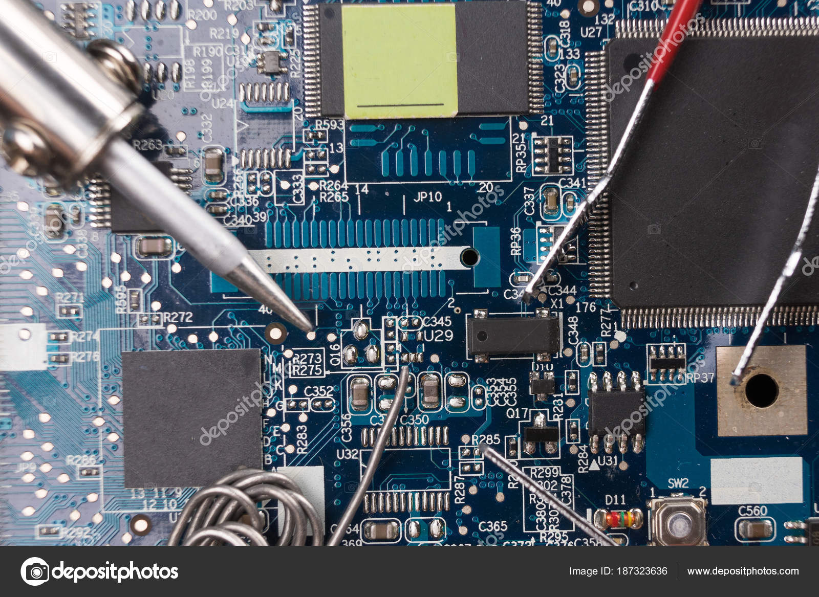 Tin the soldering iron and tweezers on the background of the ...