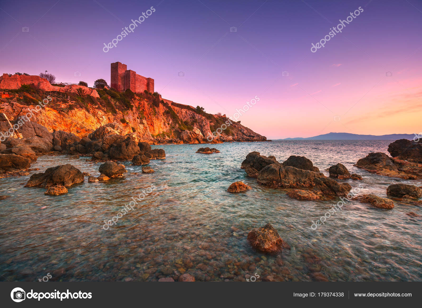 Talamone rock beach and medieval fortress at sunset. Maremma Arg Stock ...