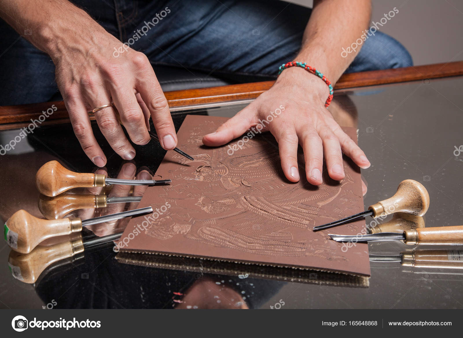 Hands of a master making a linocut Stock Photo by ©dmitrybulin 165648868