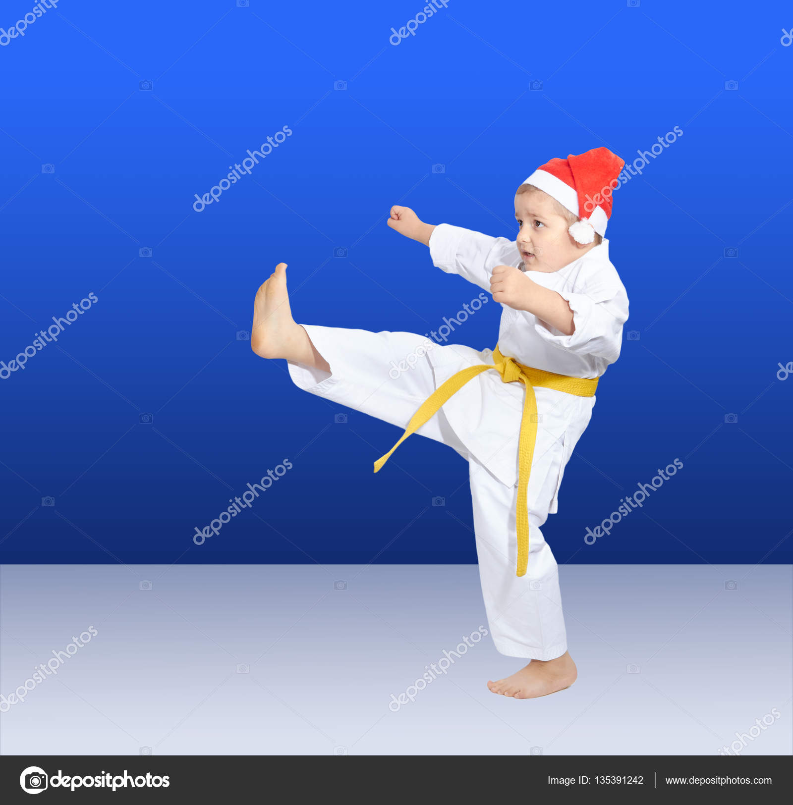On a blue background a little athlete beats a kick leg forward Stock ...