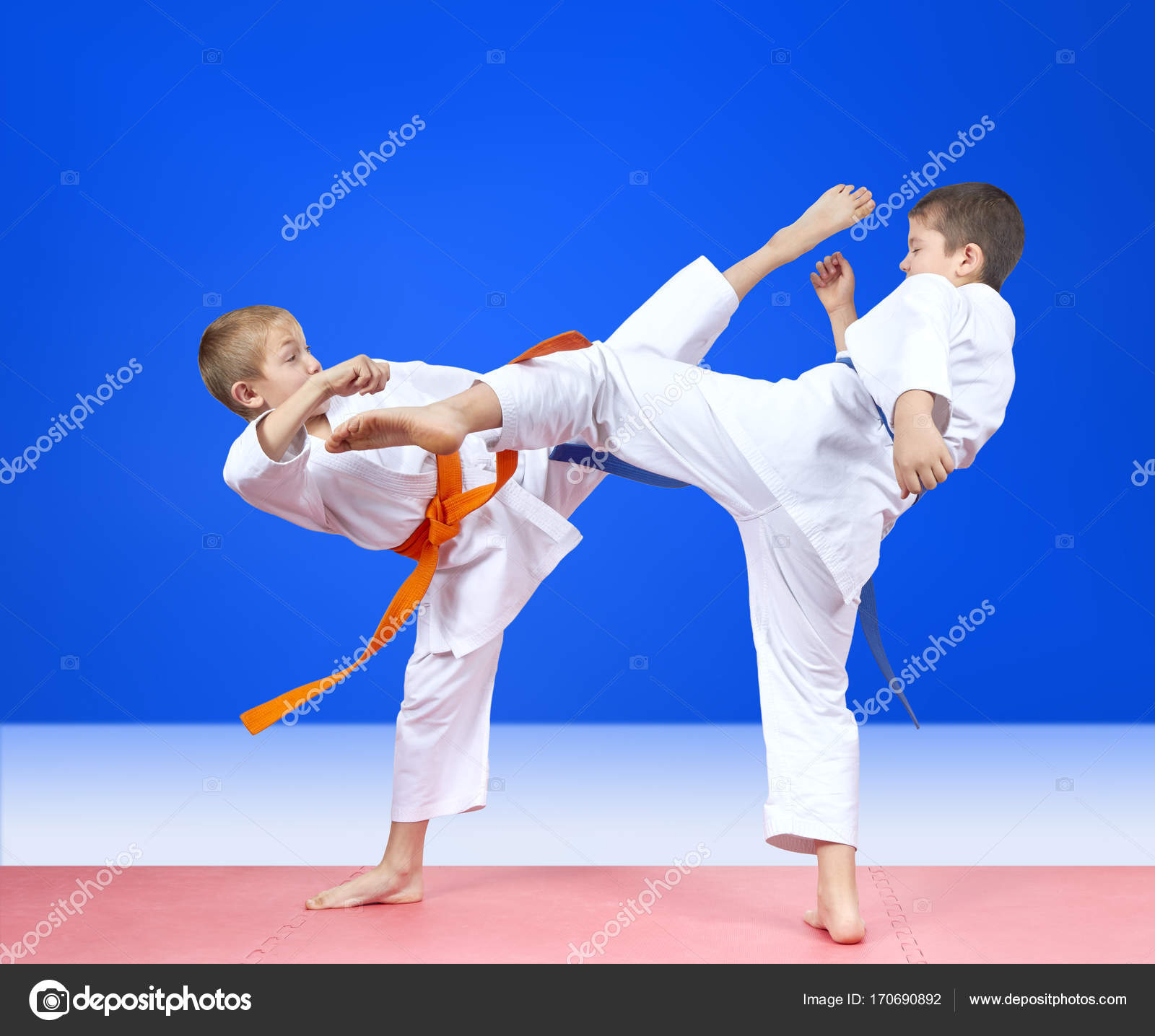 Circular kicks athletes are beating in karategi Stock Photo by ...