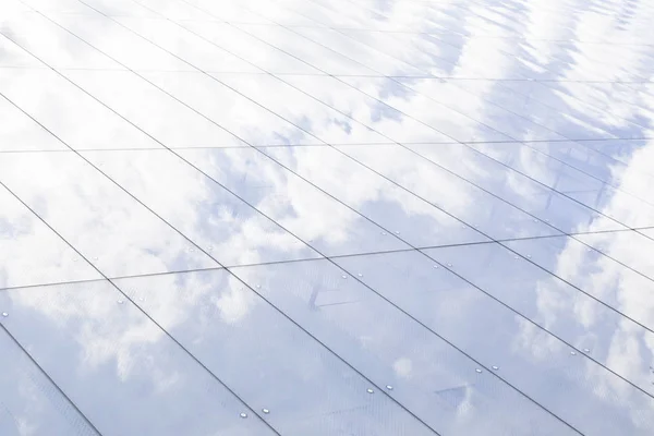 Reflection of clouds and blue sky in the glass wall of a modern — Stock ...