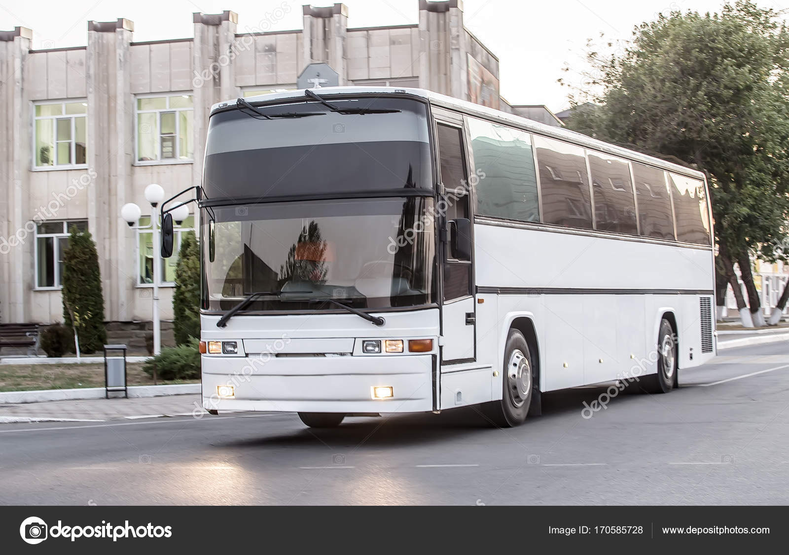 Tourist bus goes on the city street Stock Photo by ©Apriori 170585728