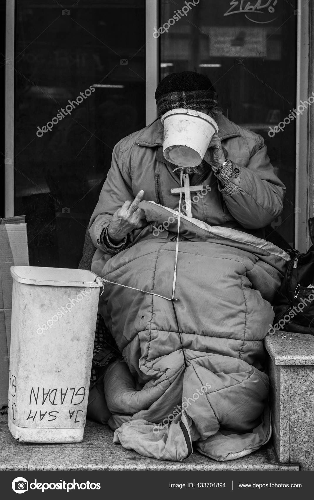 A homeless man sitting on the street — Stock Editorial Photo ...