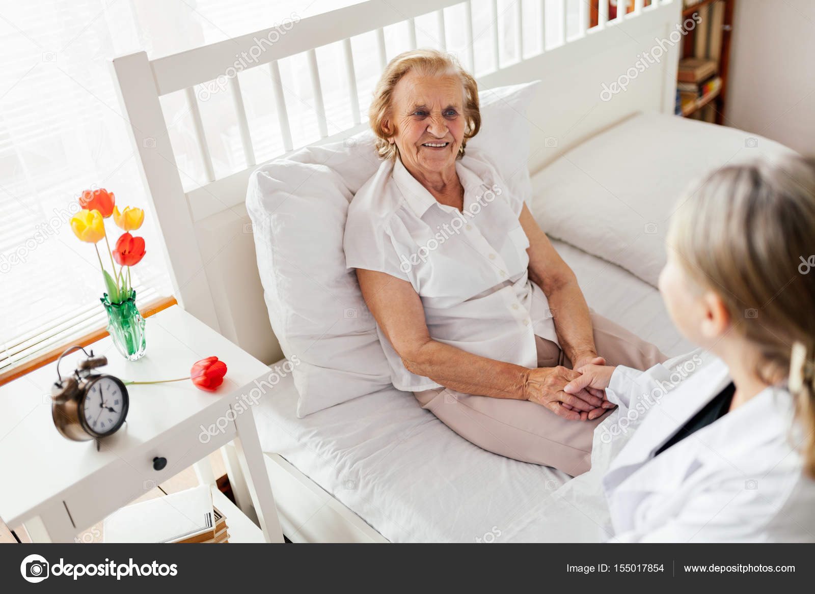 Providing care for elderly. Doctor visiting elderly patient at home ...