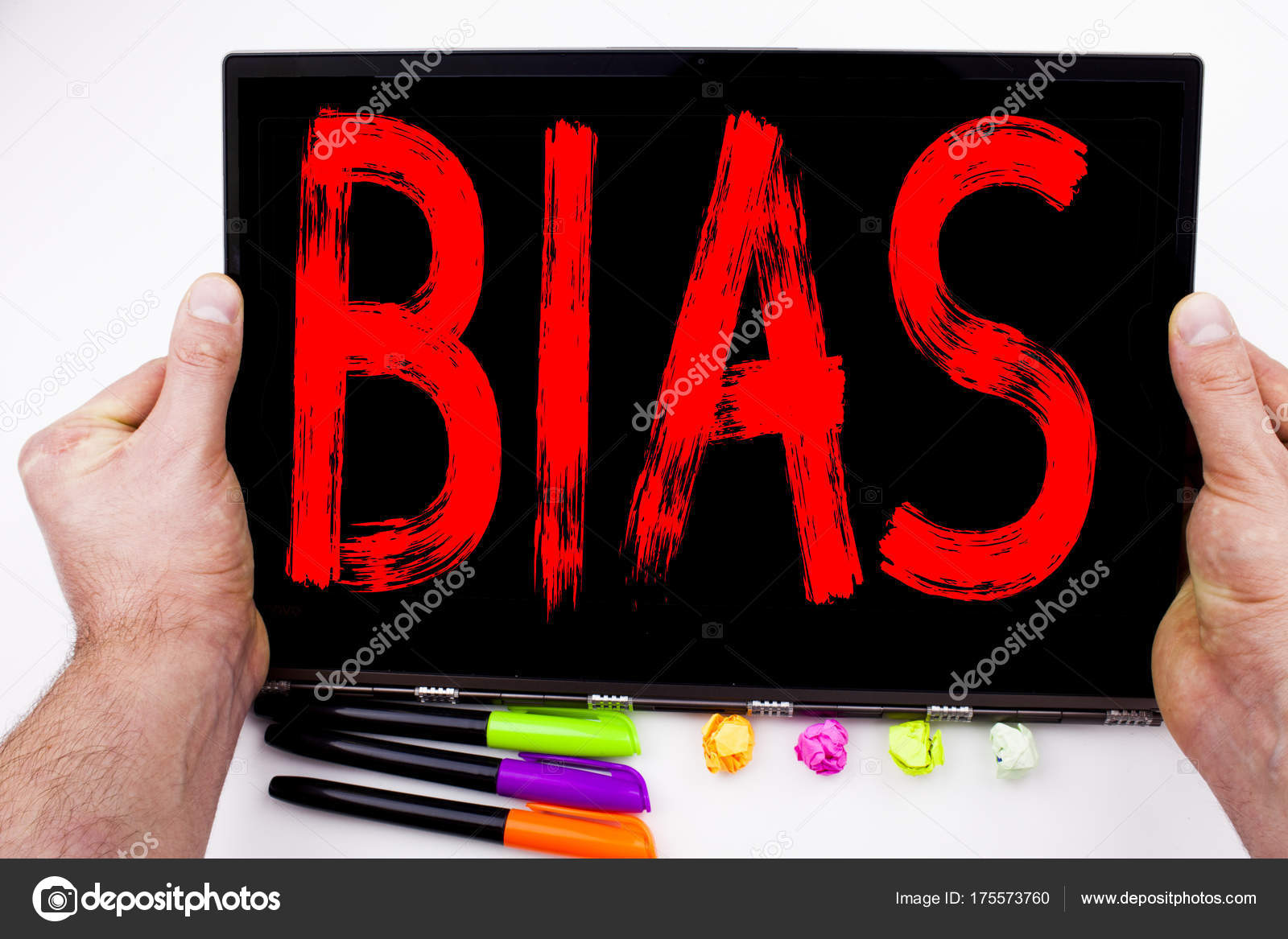 Bias text written on tablet, computer in the office with marker, pen ...