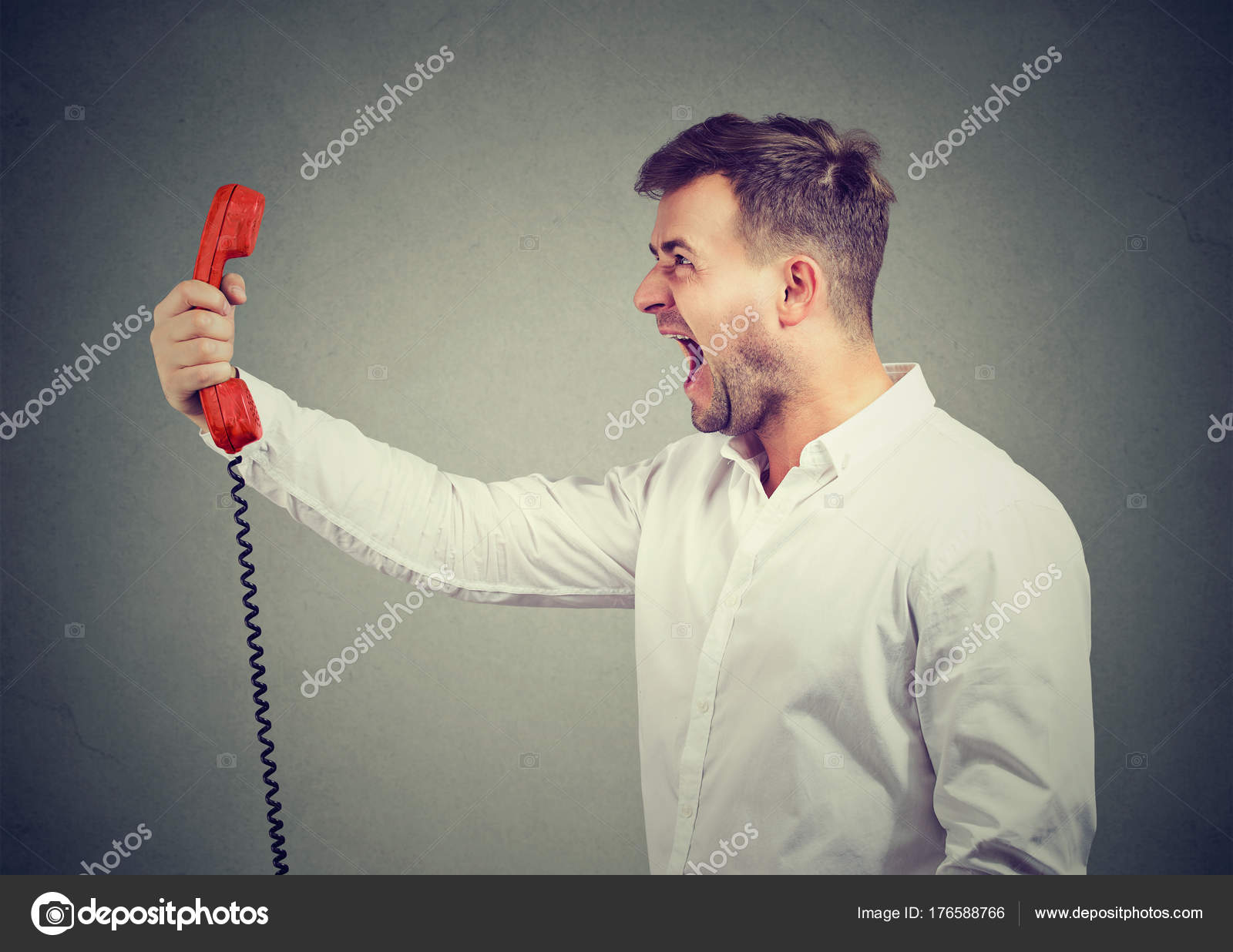 Angry man shouting at handset Stock Photo by ©Feodora52 176588766