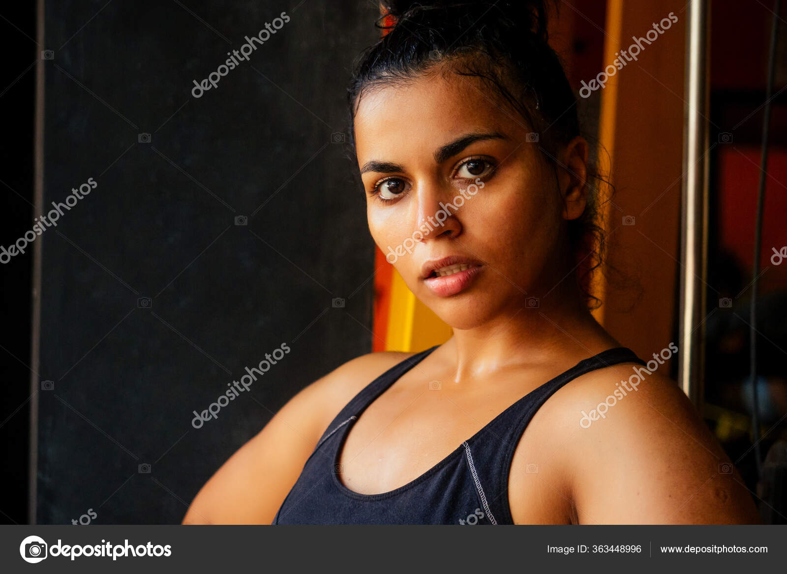 Latin american fitness model in bra top and leggings looking tired with ...