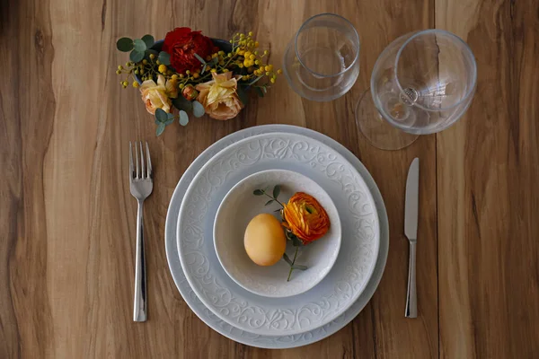 Easter table setting composition with traditional golden painted egg ...